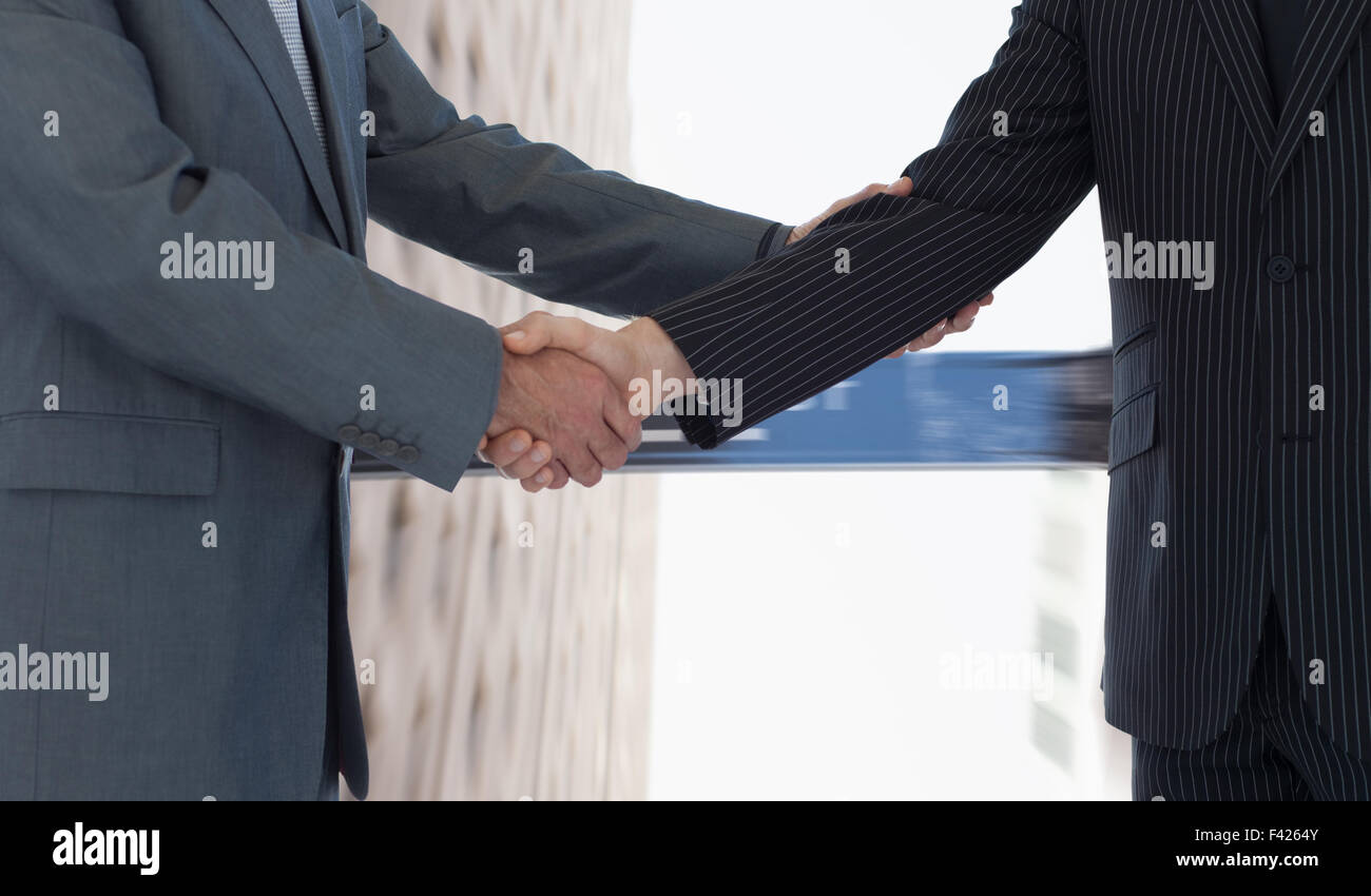 Composite image of handshake in agreement Stock Photo - Alamy