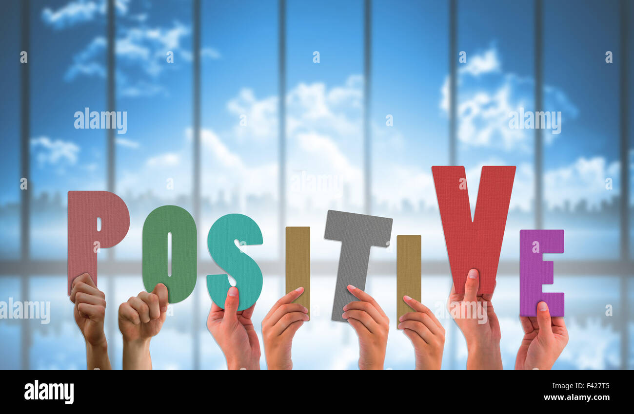 Composite image of hands holding up positive Stock Photo - Alamy