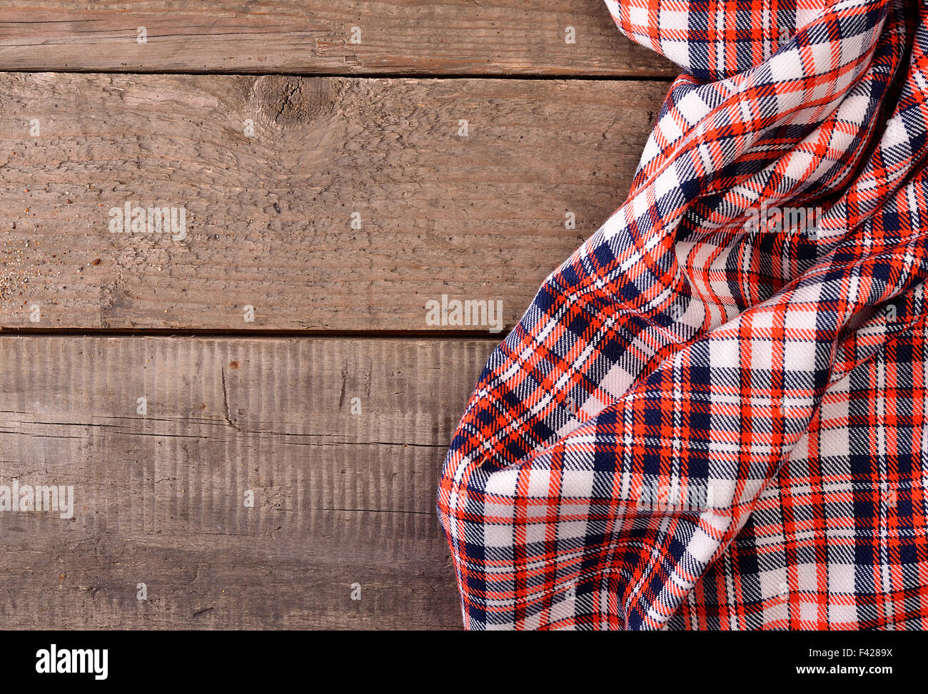 Checkered table cloth on an old wooden table Stock Photo - Alamy