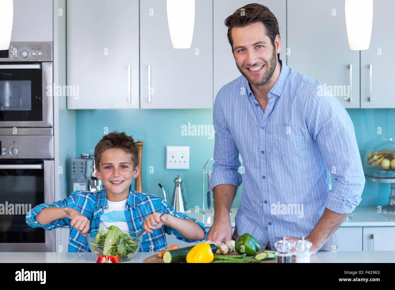 Happy family preparing lunch together Stock Photo - Alamy