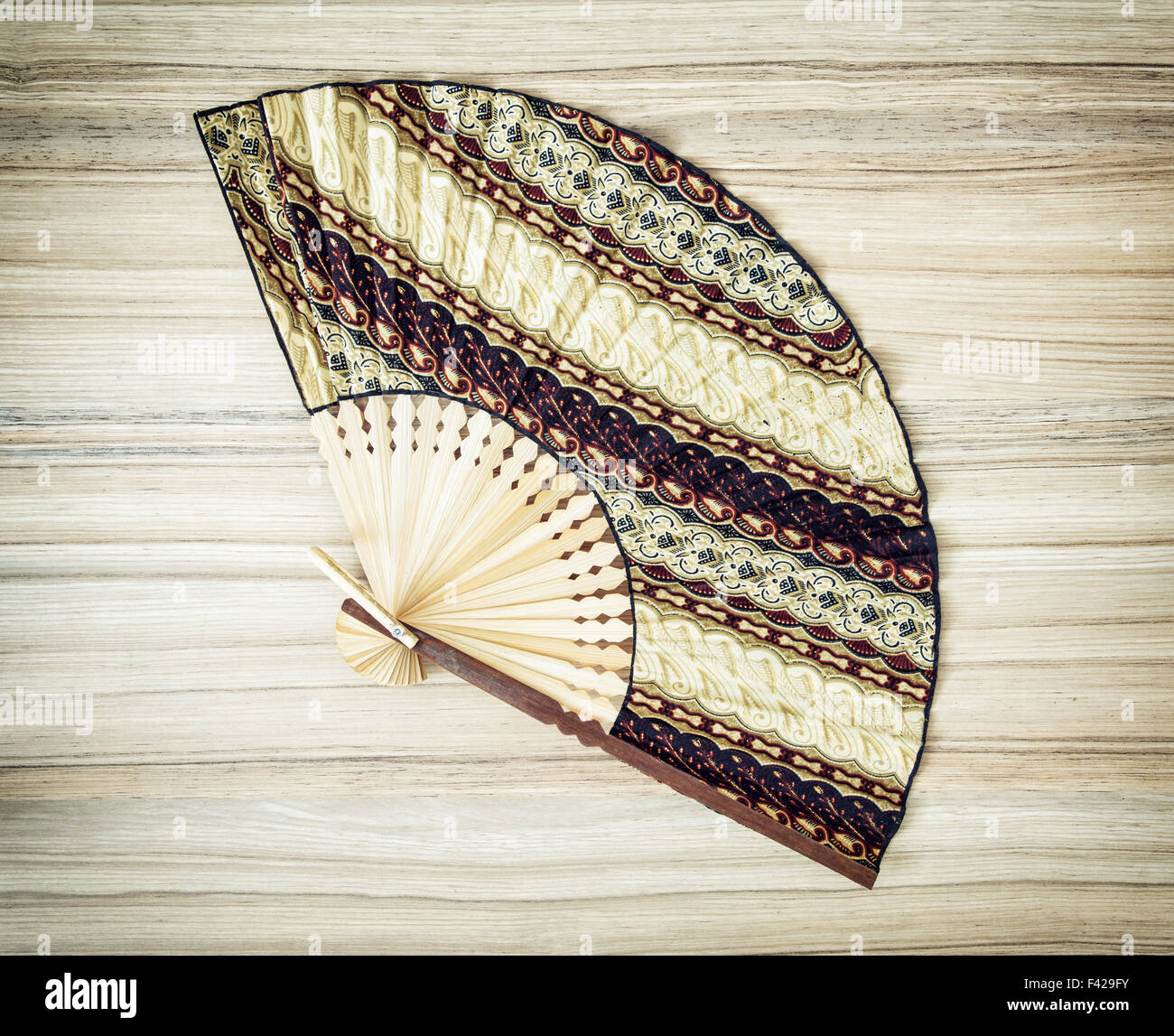 Traditional eastern fan on the wooden background Stock Photo - Alamy