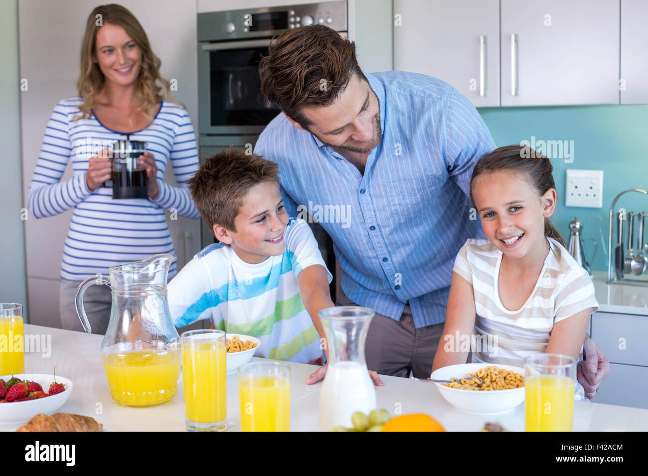 Happy family having breakfast together Stock Photo - Alamy