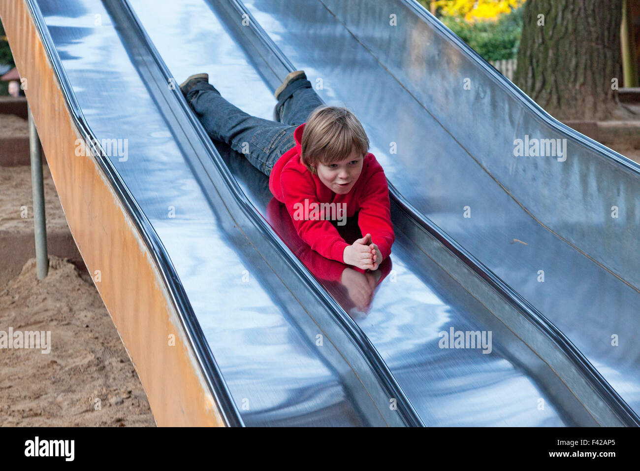 young boy on a slide Stock Photo - Alamy