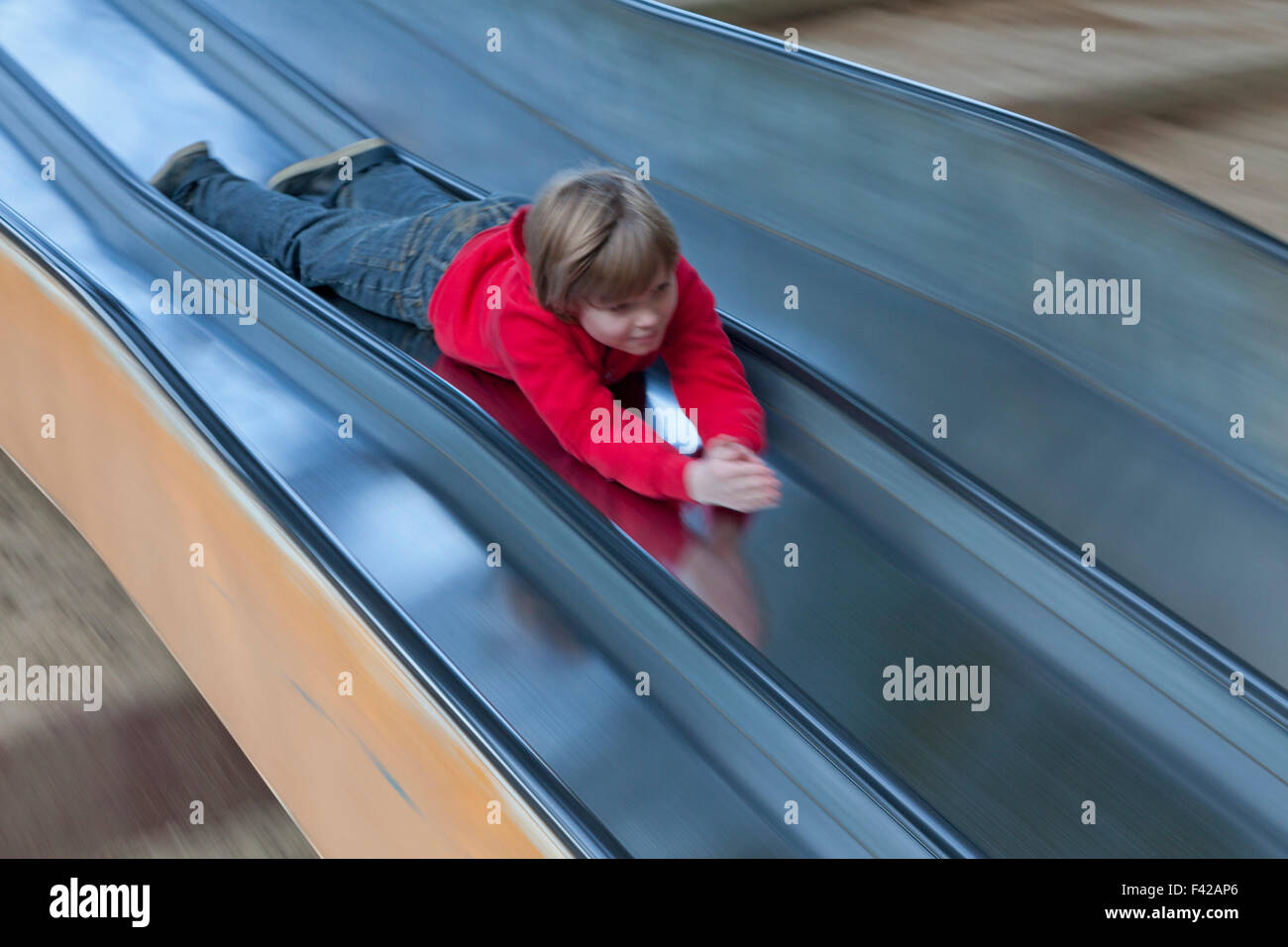 young boy on a slide Stock Photo - Alamy