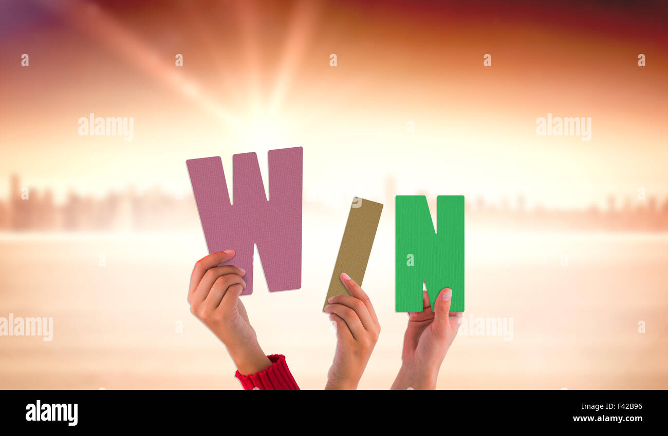 Composite image of hands showing win Stock Photo - Alamy
