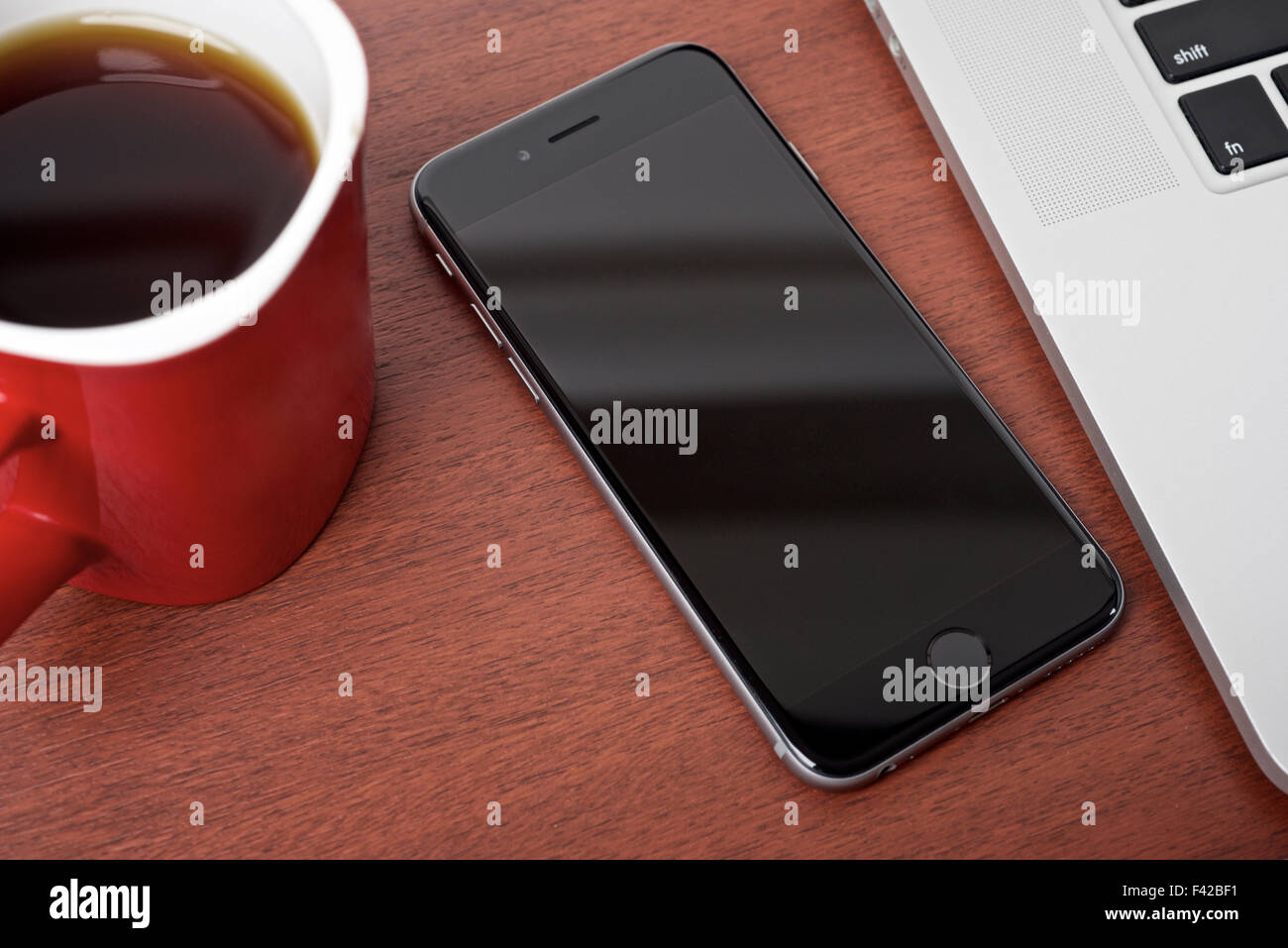 Coffee work table with mobile phone and laptop on a wooden pattern ...