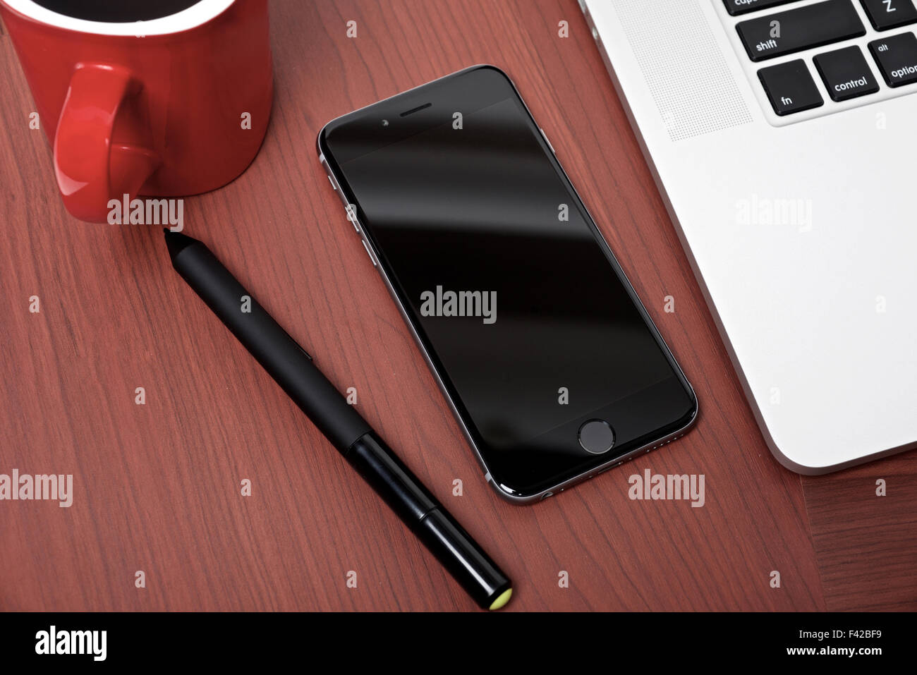 Coffee work table with mobile phone and laptop and a digital pen on a ...