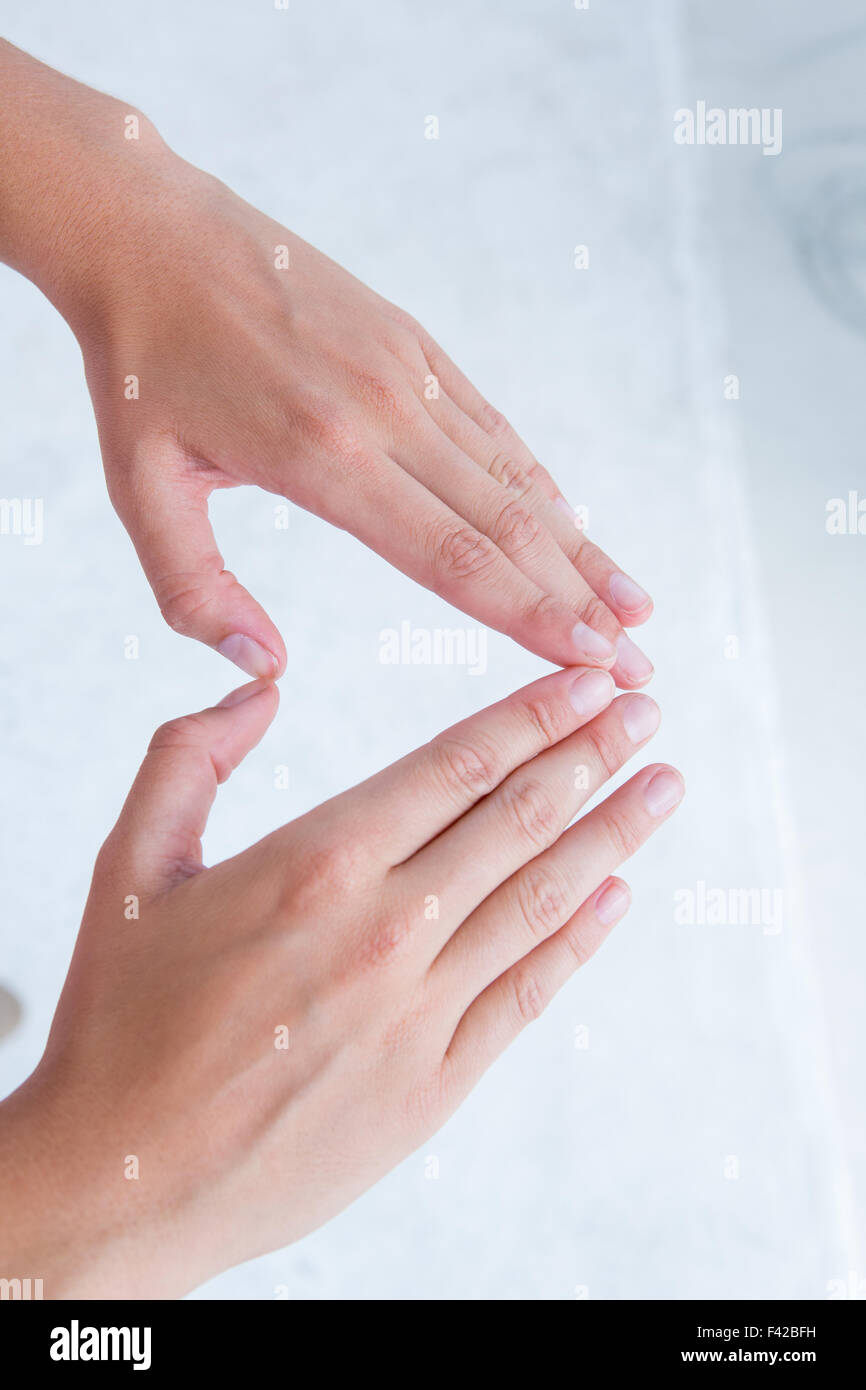 Woman making heart shape with hands Stock Photo - Alamy