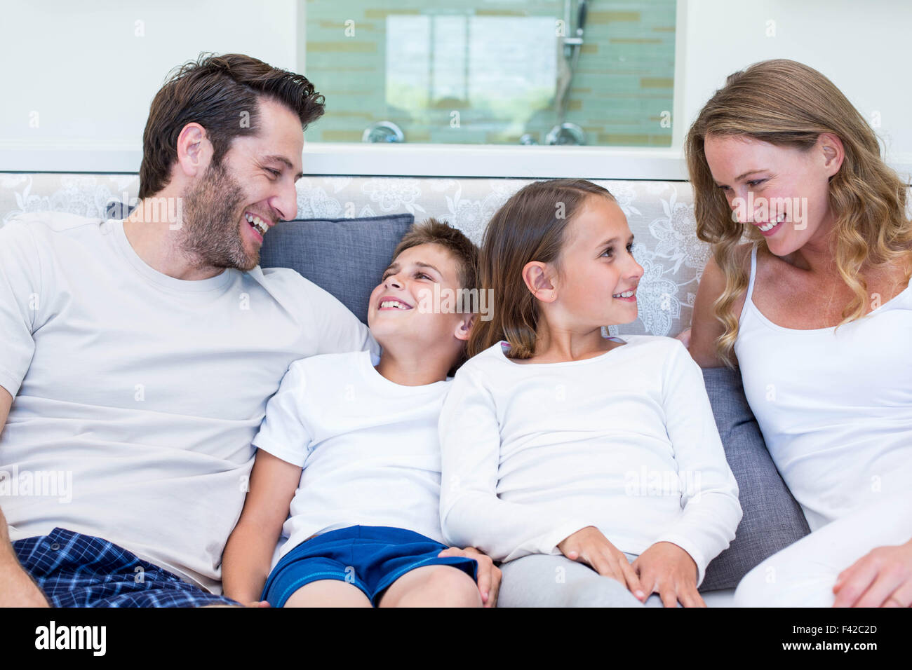 Happy family smiling at each other Stock Photo - Alamy
