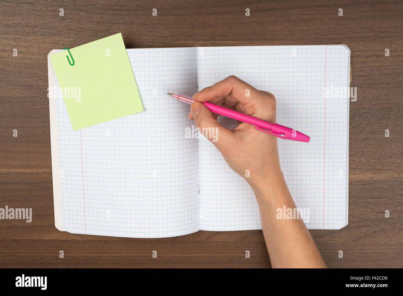 Womans writing hand on table Stock Photo - Alamy