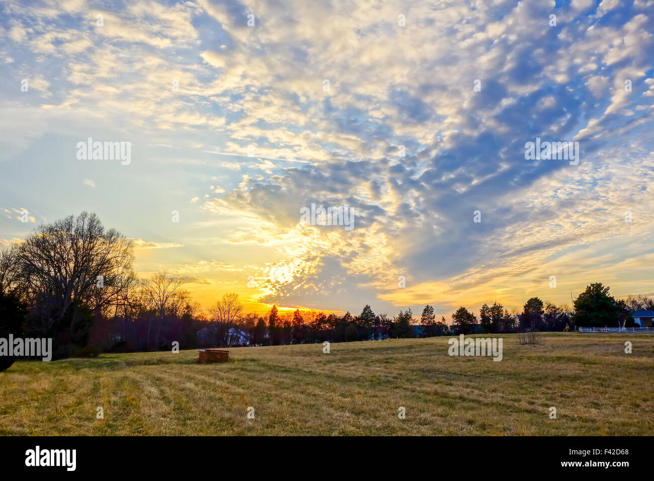 sunset over farm field landscape Stock Photo - Alamy
