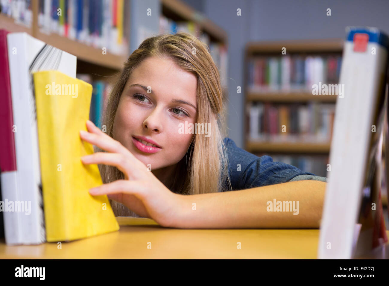 Pretty student in the library Stock Photo - Alamy
