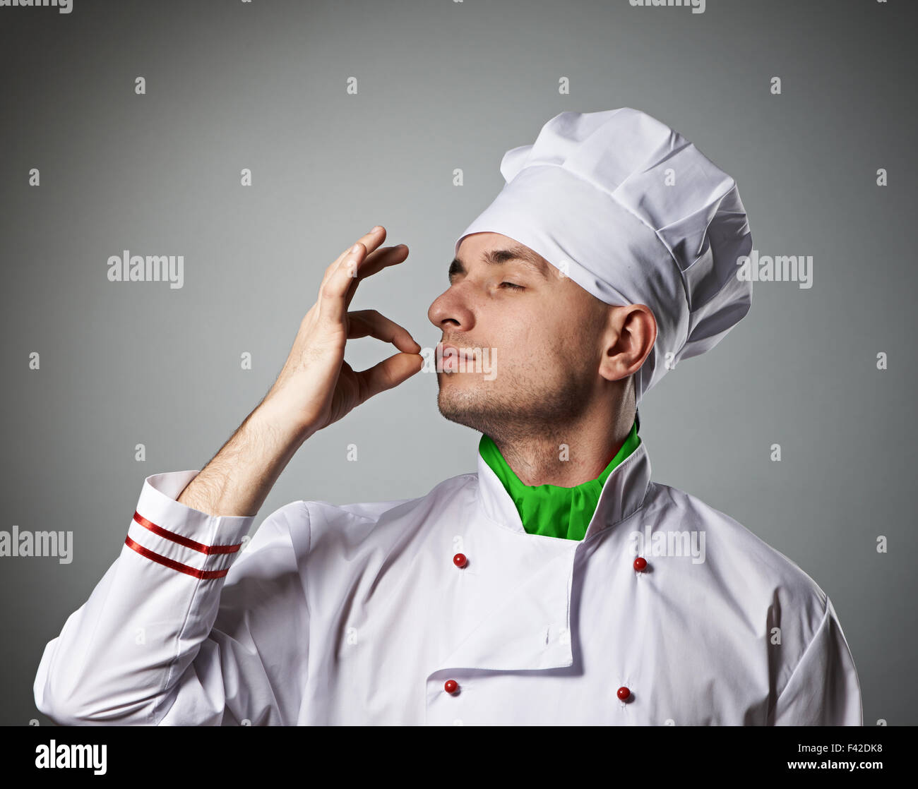 Male chef kissing fingers Stock Photo - Alamy