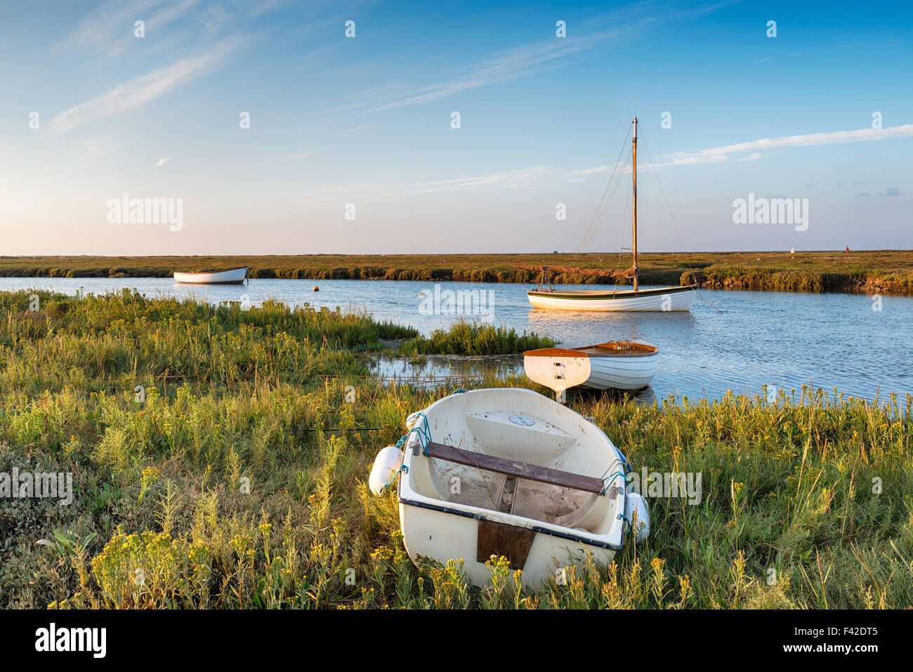 Boats on the salt marshes at Blakeney on the north coast of Norfolk ...