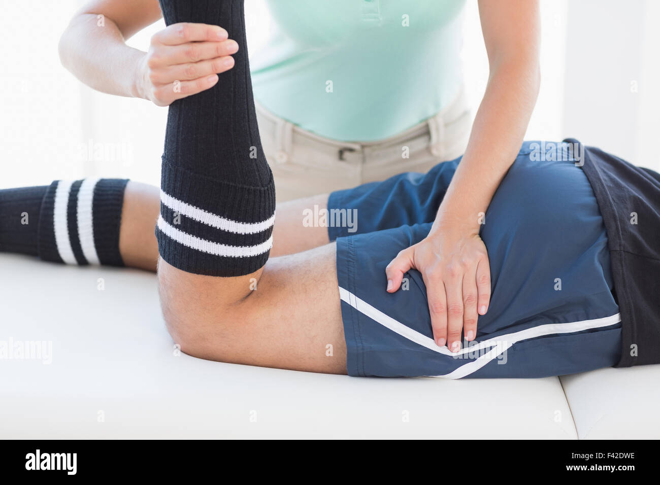 Doctor manipulating leg patient hi-res stock photography and images - Alamy