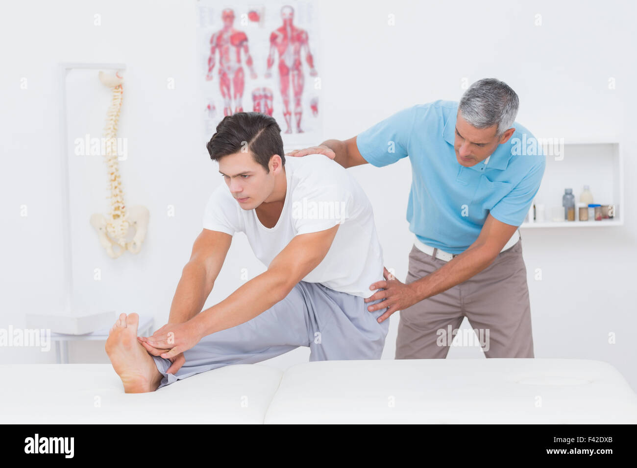 Doctor examining his patient back Stock Photo - Alamy