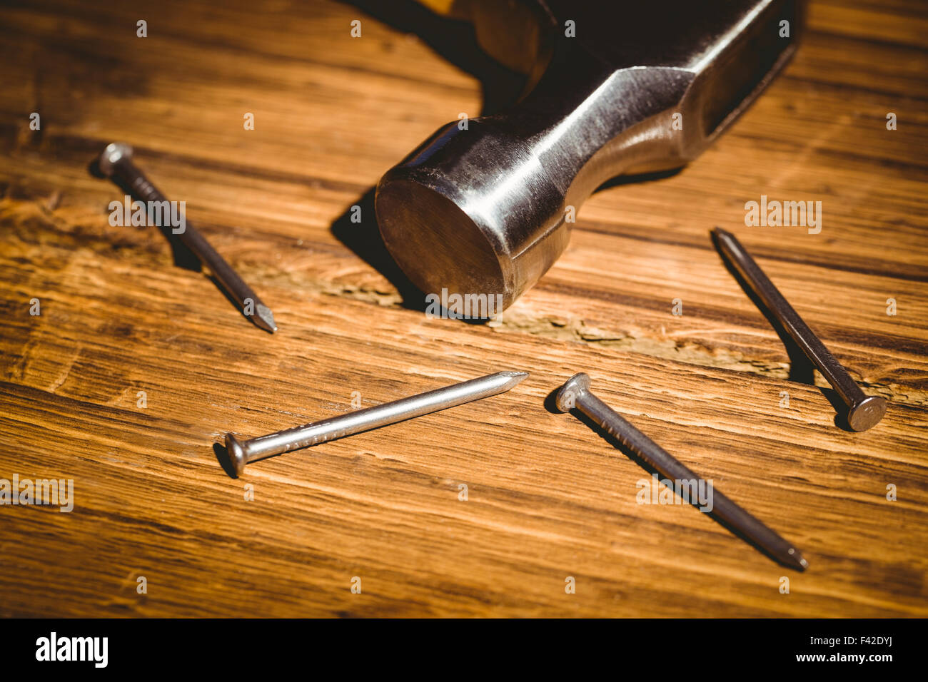 Hammer and nails laid out on table Stock Photo - Alamy