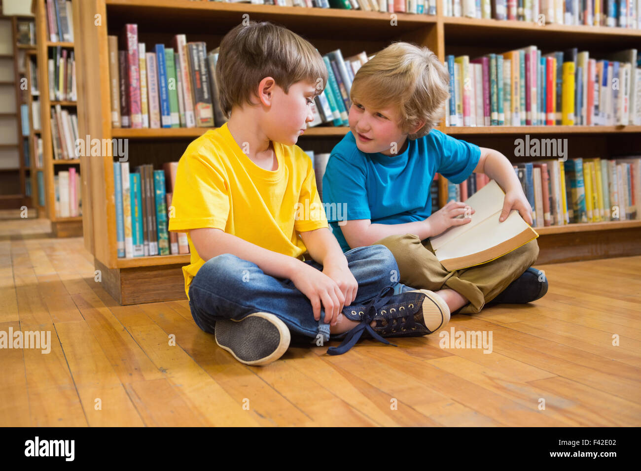 Pupils reading book Stock Photo - Alamy