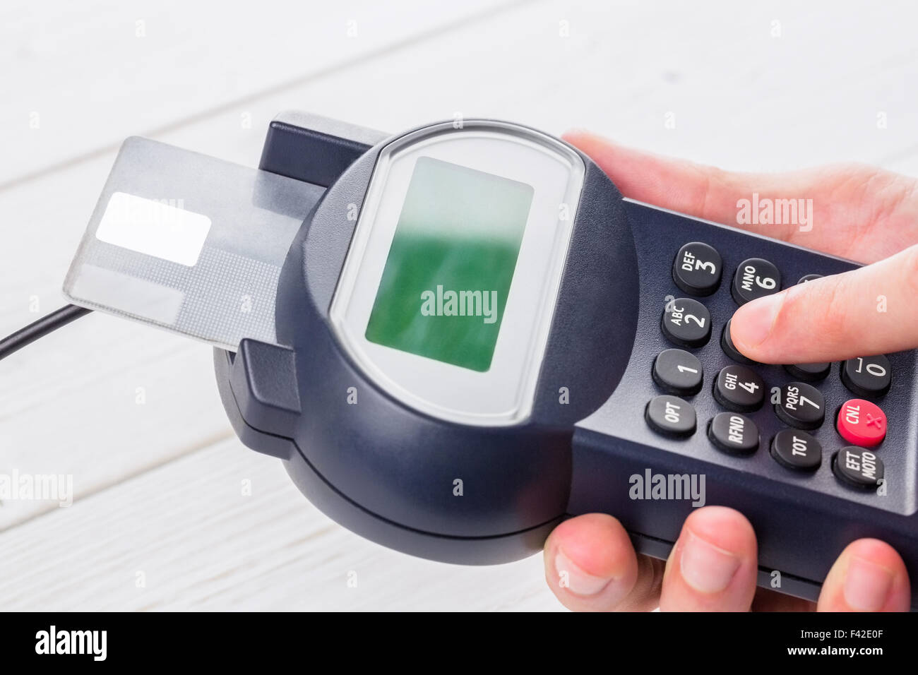 Man entering his pin on terminal Stock Photo - Alamy