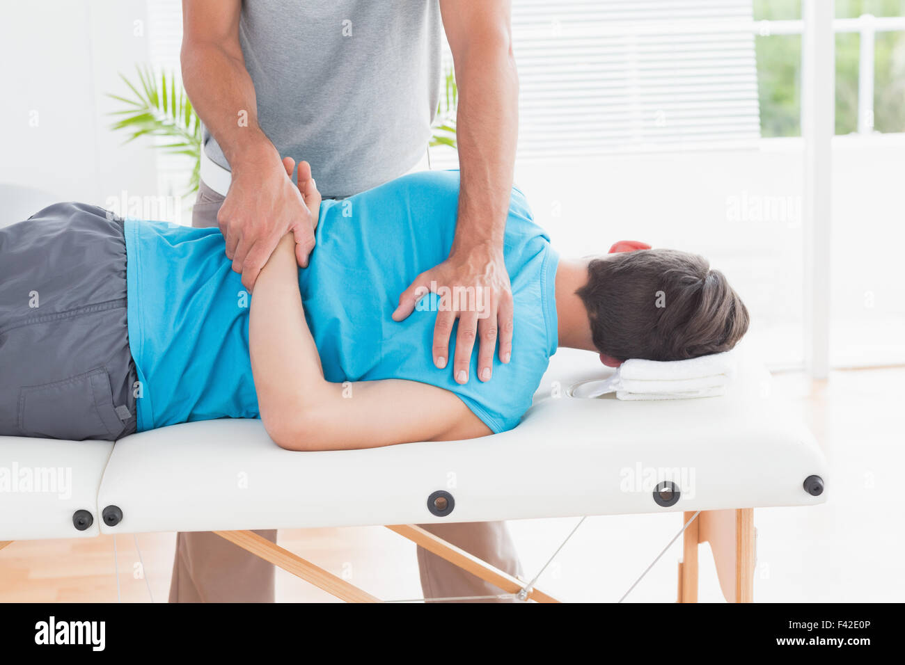 Doctor examining his patient back Stock Photo - Alamy