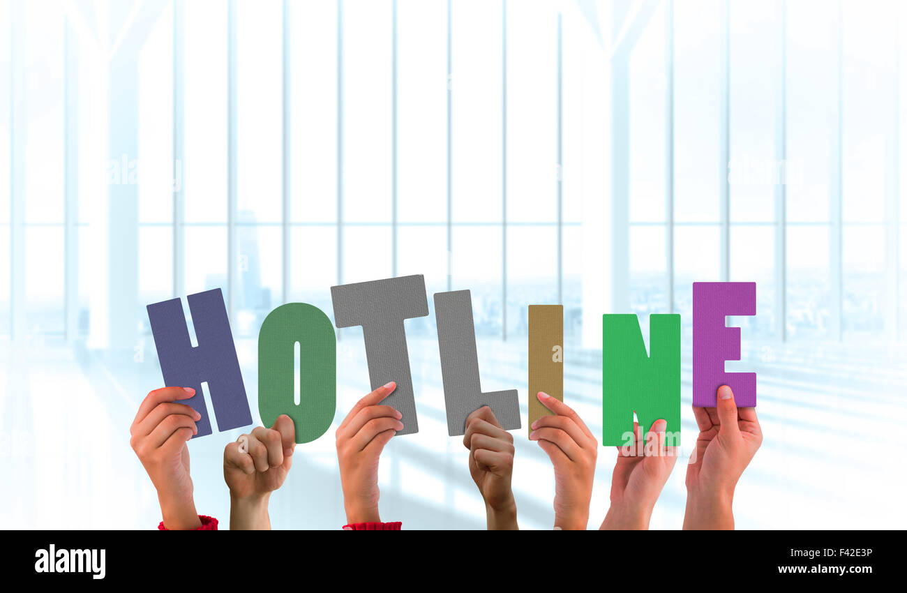 Composite image of hands holding up hotline Stock Photo - Alamy