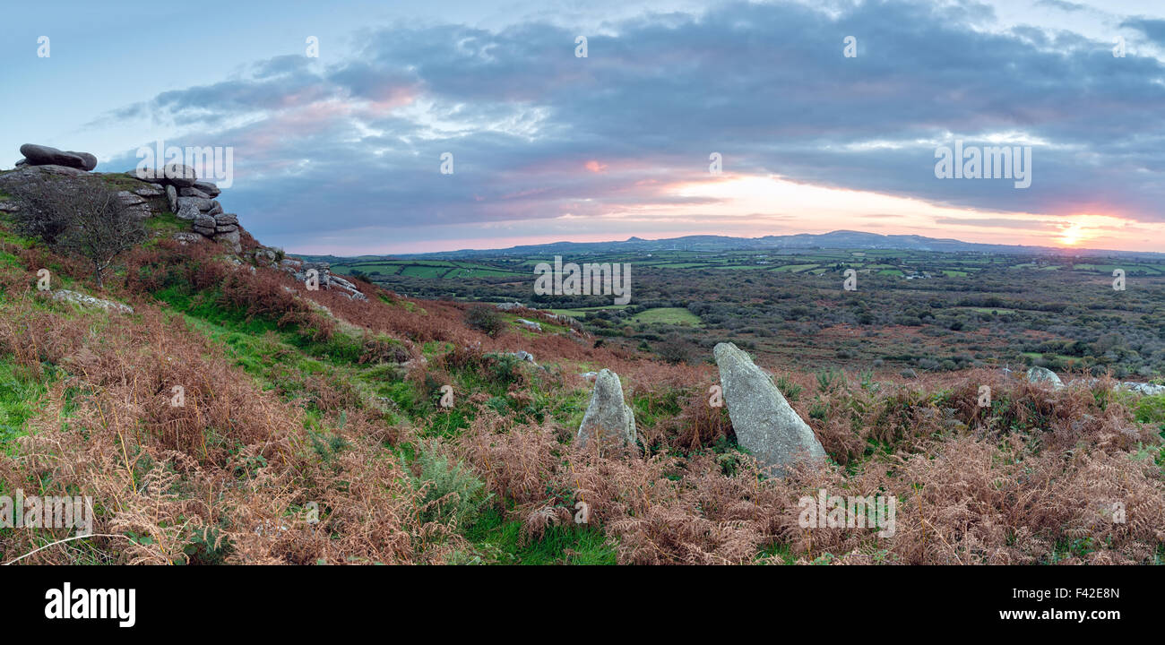 A panoramic view of an Autumn sunset over Helman Tor a steep craggy ...