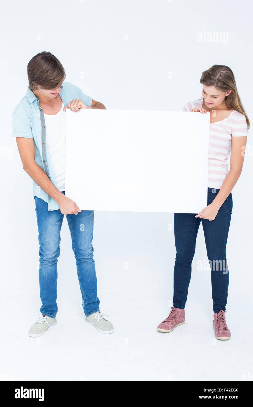 Hipster couple holding poster Stock Photo - Alamy