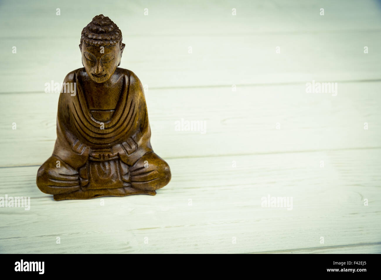 Buddha statue on a table Stock Photo - Alamy