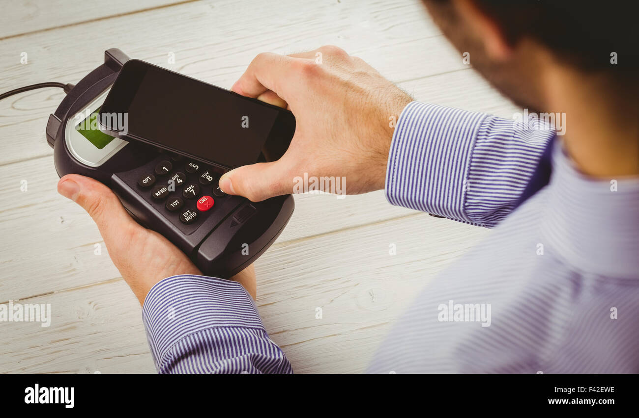 Man using smartphone to express pay Stock Photo - Alamy