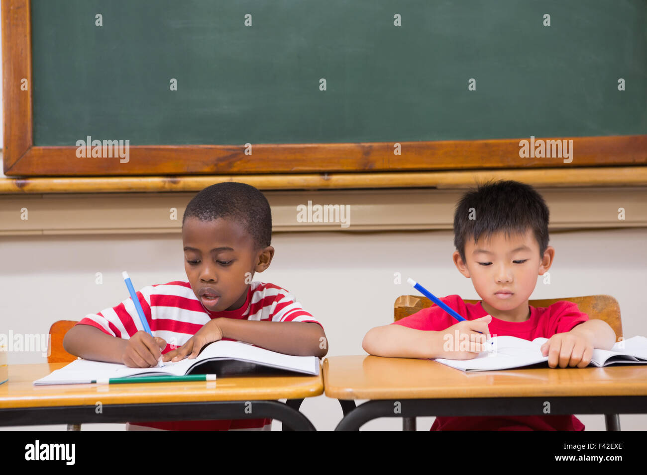 Cute pupils writing desk in hi-res stock photography and images - Alamy