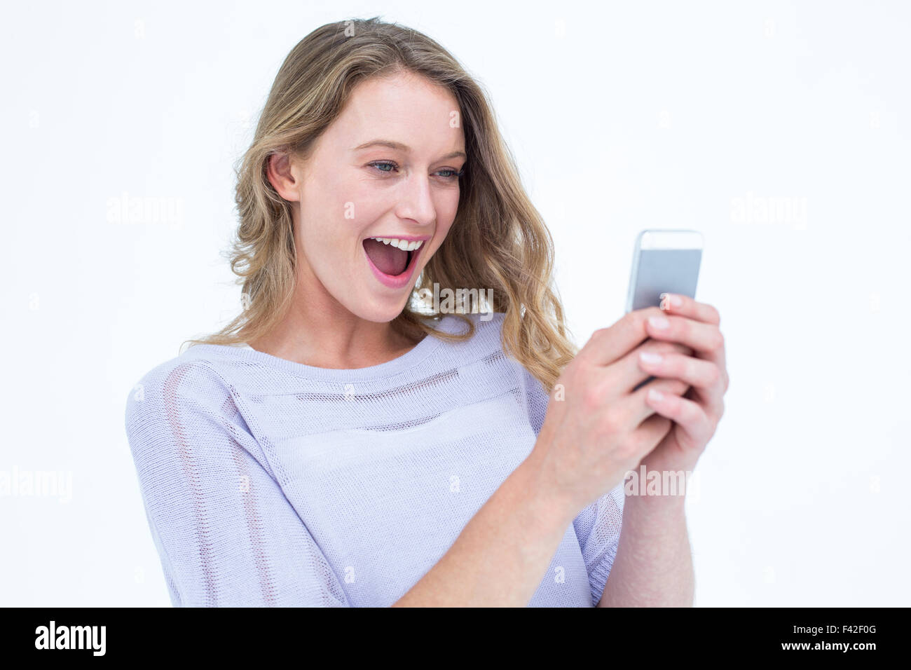 Smiling woman using smartphone Stock Photo - Alamy