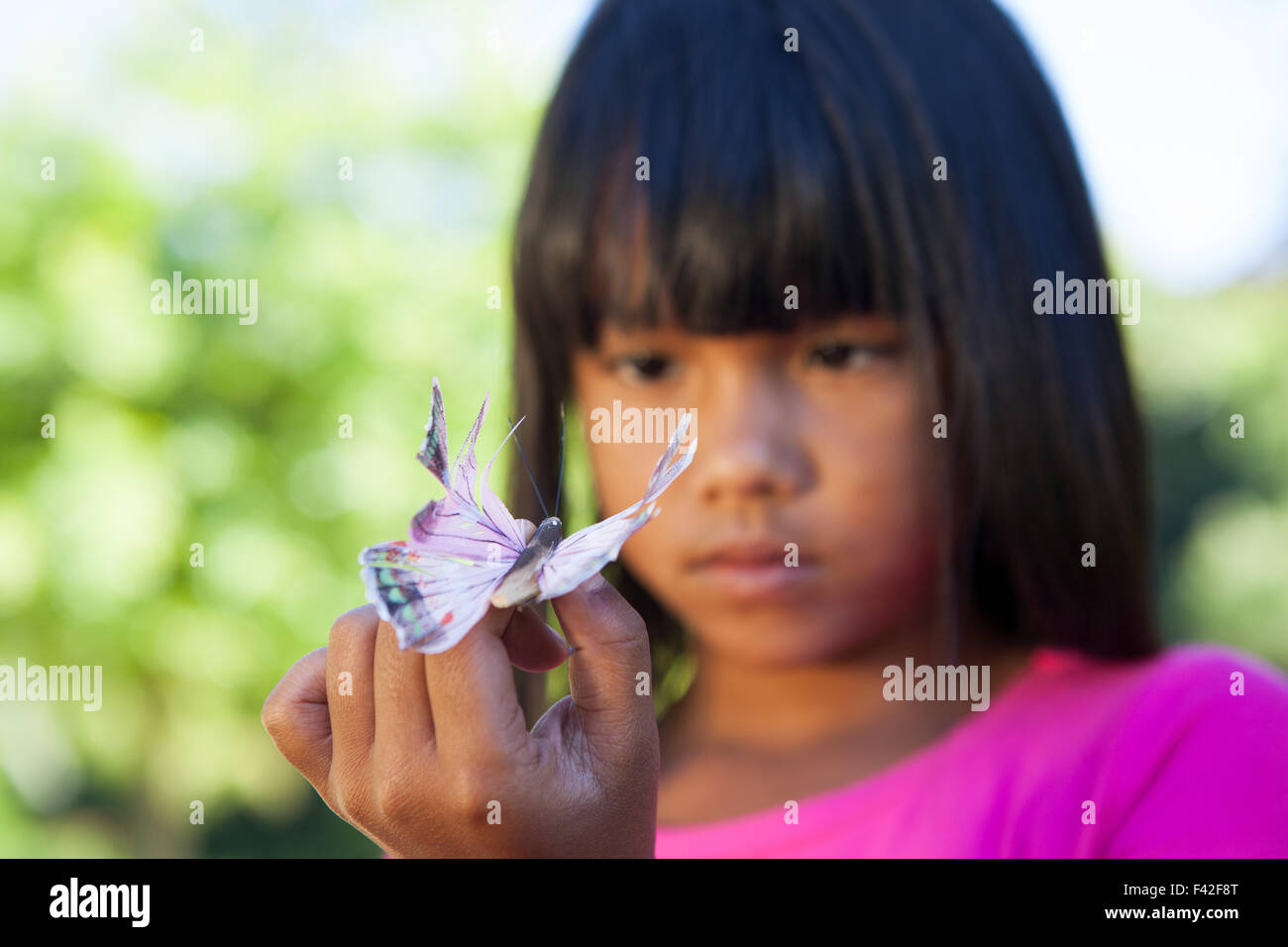 Cute little girl holding butterfly Stock Photo - Alamy