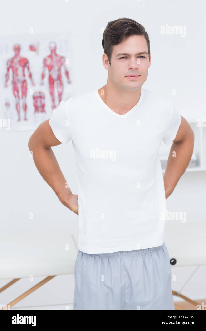 Suffering patient touching his back Stock Photo - Alamy