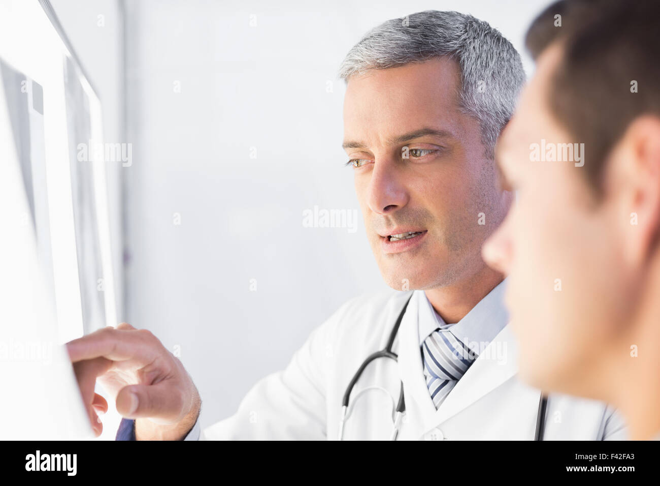 Doctor showing X rays to his patient Stock Photo - Alamy