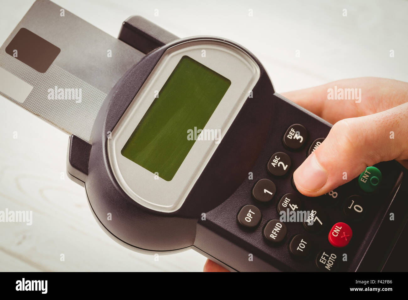 Man entering his pin on terminal Stock Photo - Alamy