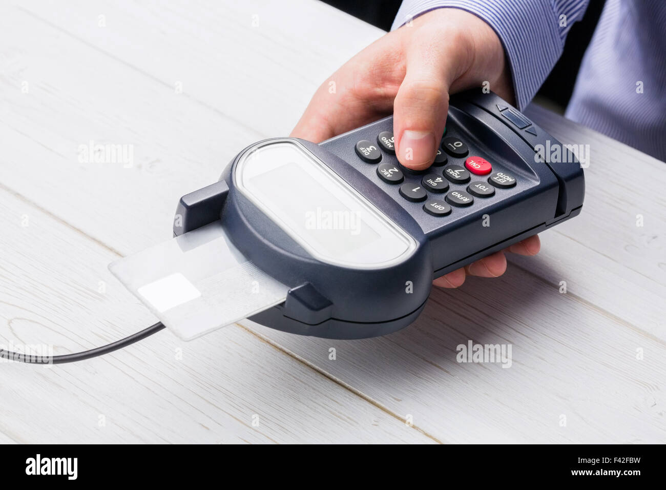 Man entering his pin on terminal Stock Photo - Alamy