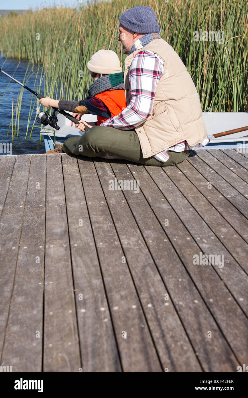 Happy man fishing with his son Stock Photo - Alamy