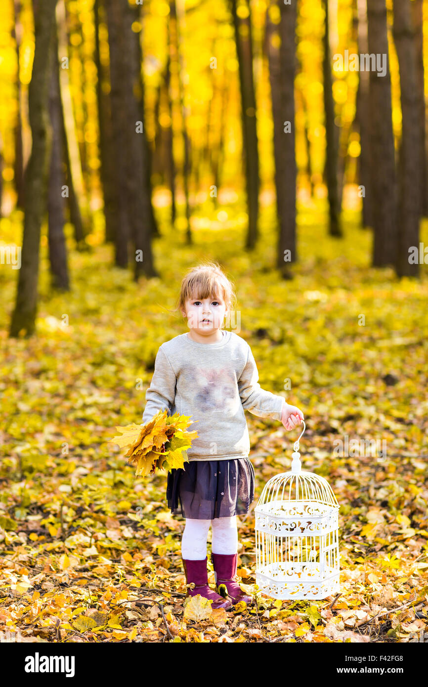 Cute baby girl in the autumn forest Stock Photo - Alamy