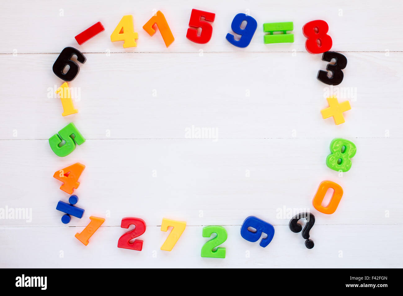 Colorful plastic numbers laid on wooden background Stock Photo - Alamy