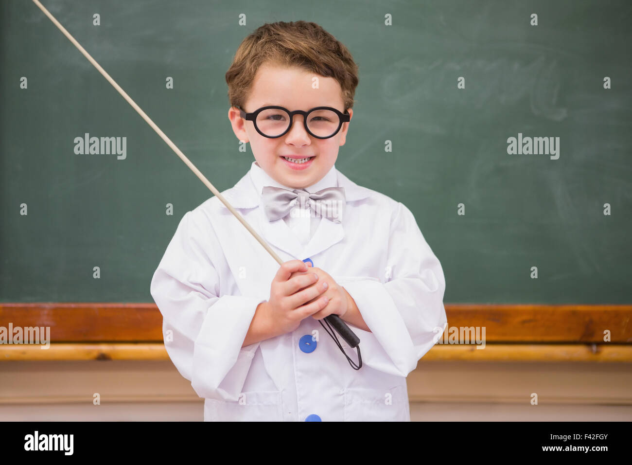 Cute pupils holding stick Stock Photo - Alamy