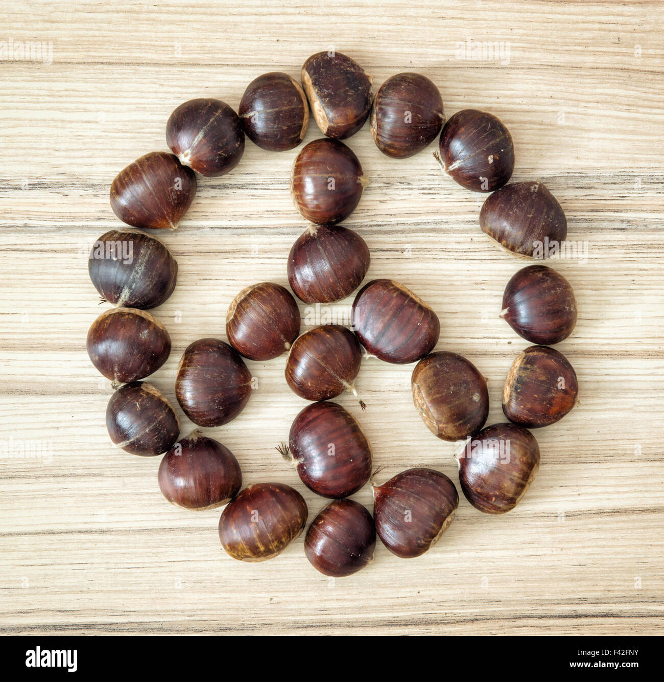 Chestnuts in the shape of peace symbol. Seasonal theme Stock Photo - Alamy