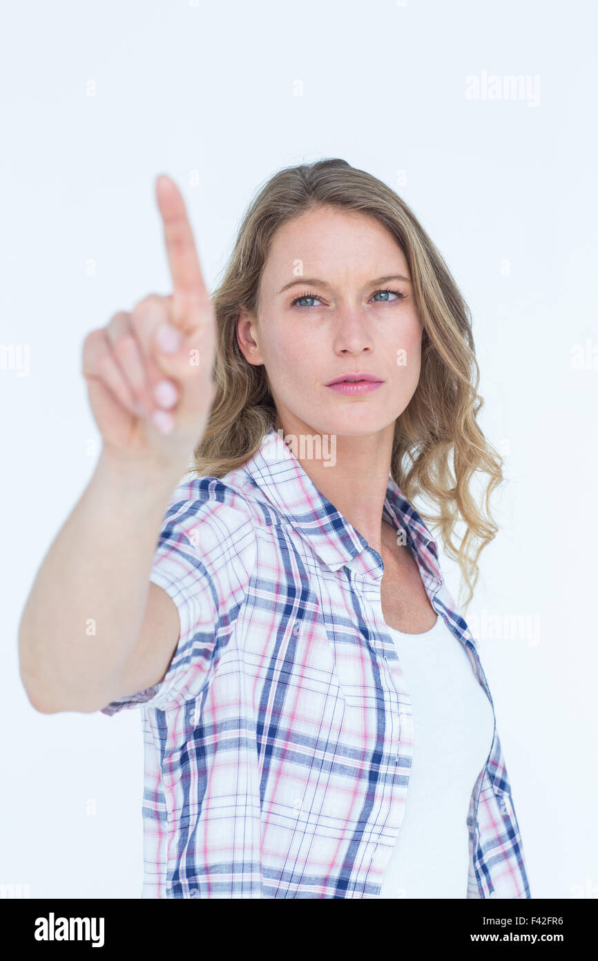 Concentrated pretty hipster pointing Stock Photo - Alamy