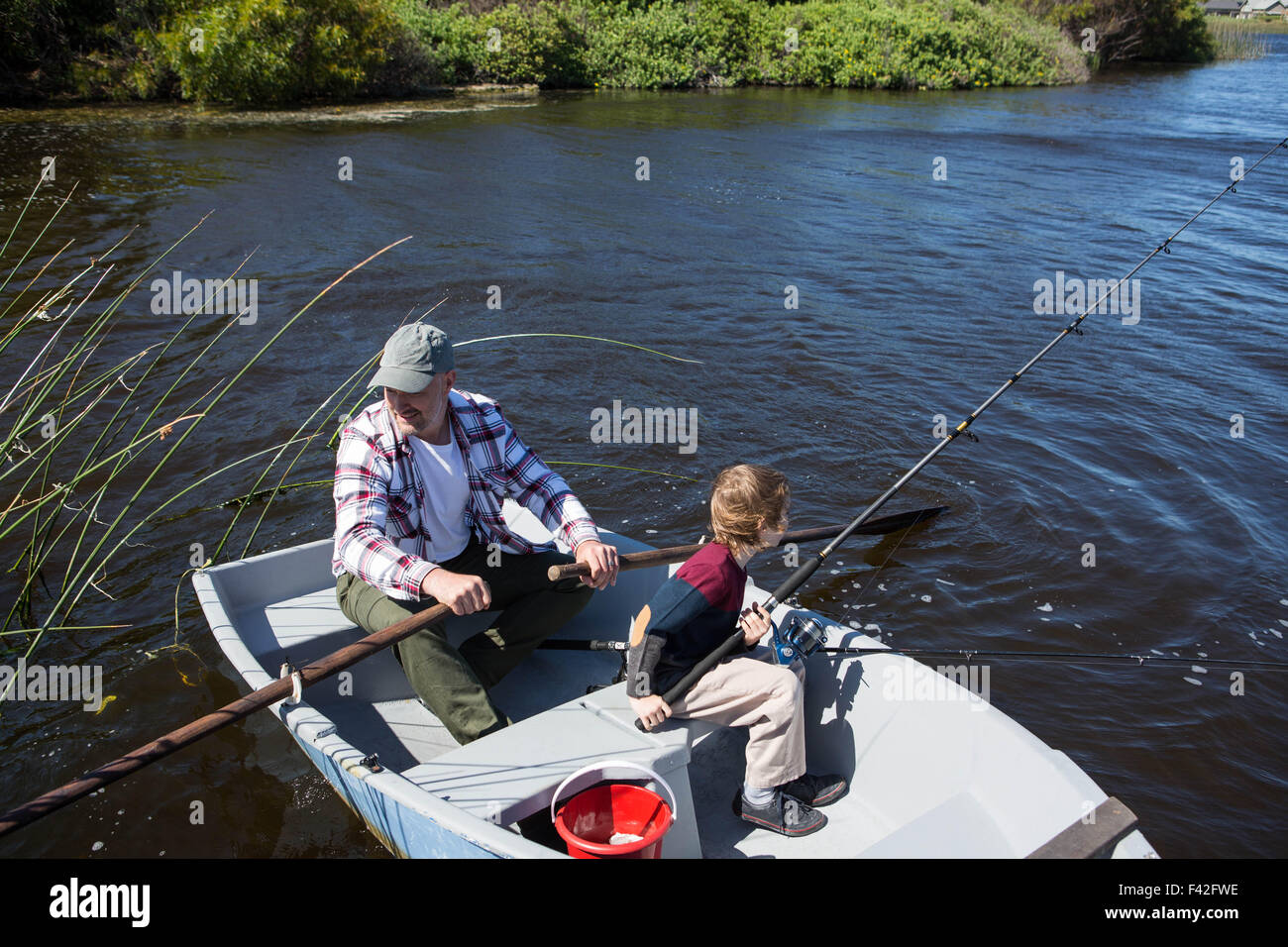 Happy man fishing with his son Stock Photo - Alamy