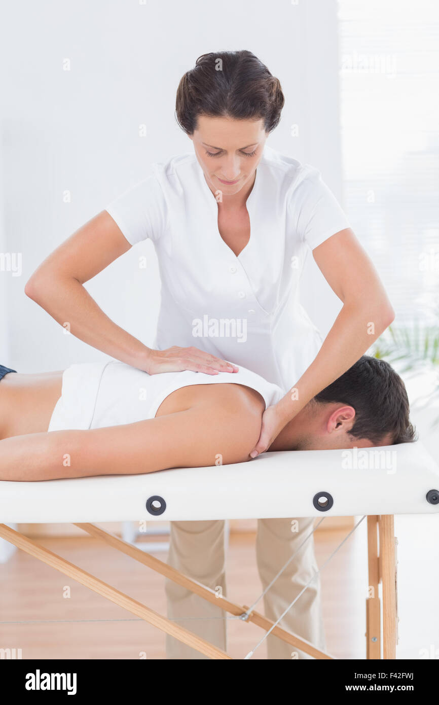 Physiotherapist doing back massage Stock Photo - Alamy