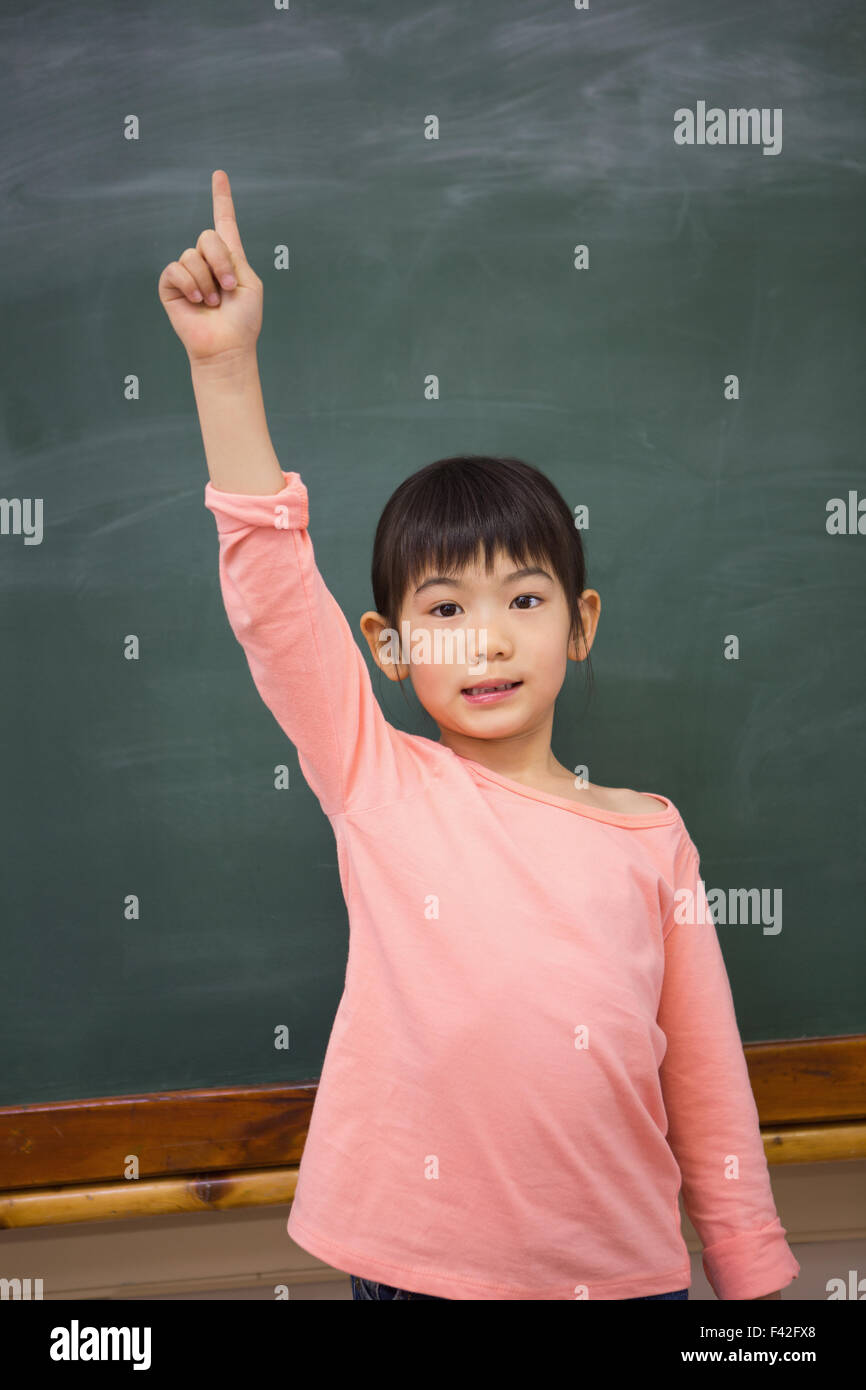 Cute pupil raising her hand Stock Photo - Alamy