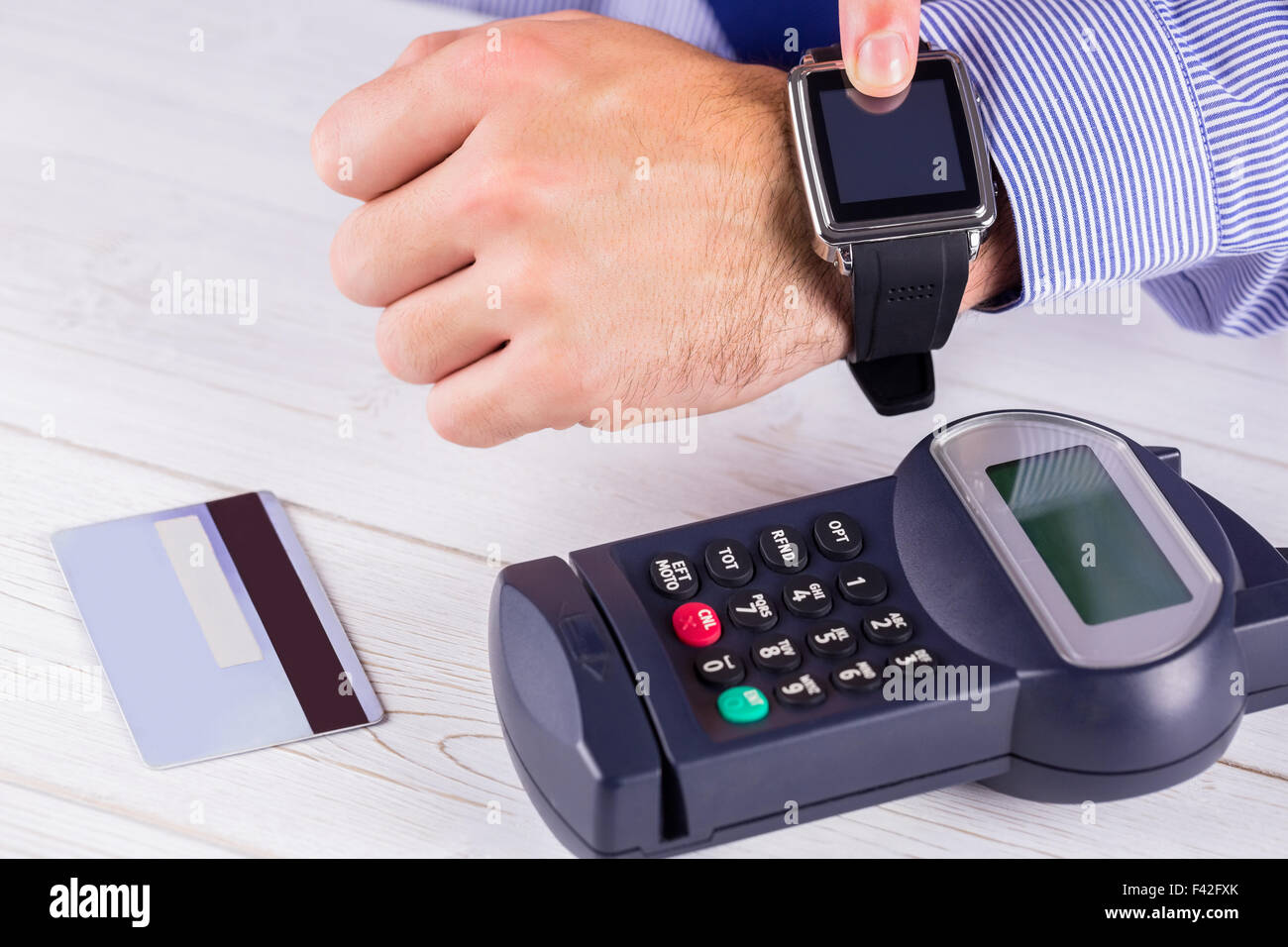 Man using smart watch to express pay Stock Photo - Alamy