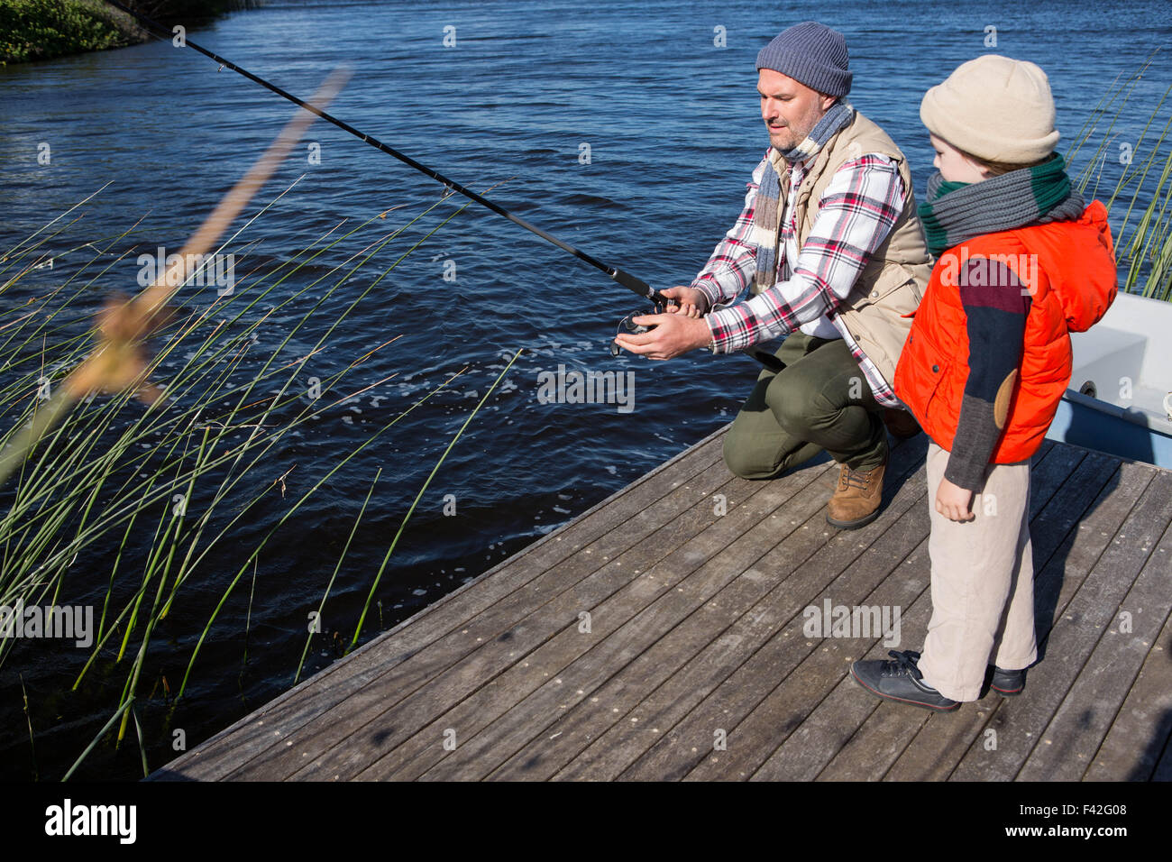 Happy man fishing with his son Stock Photo - Alamy