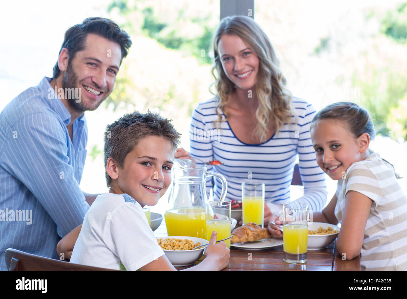 Happy family having breakfast together Stock Photo - Alamy