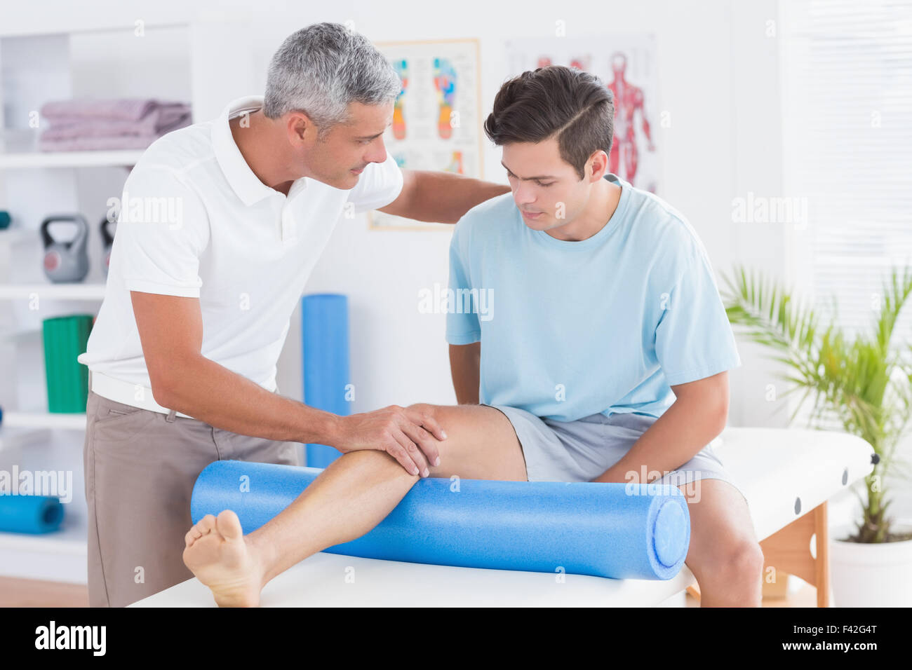 Doctor examining his patient leg Stock Photo - Alamy