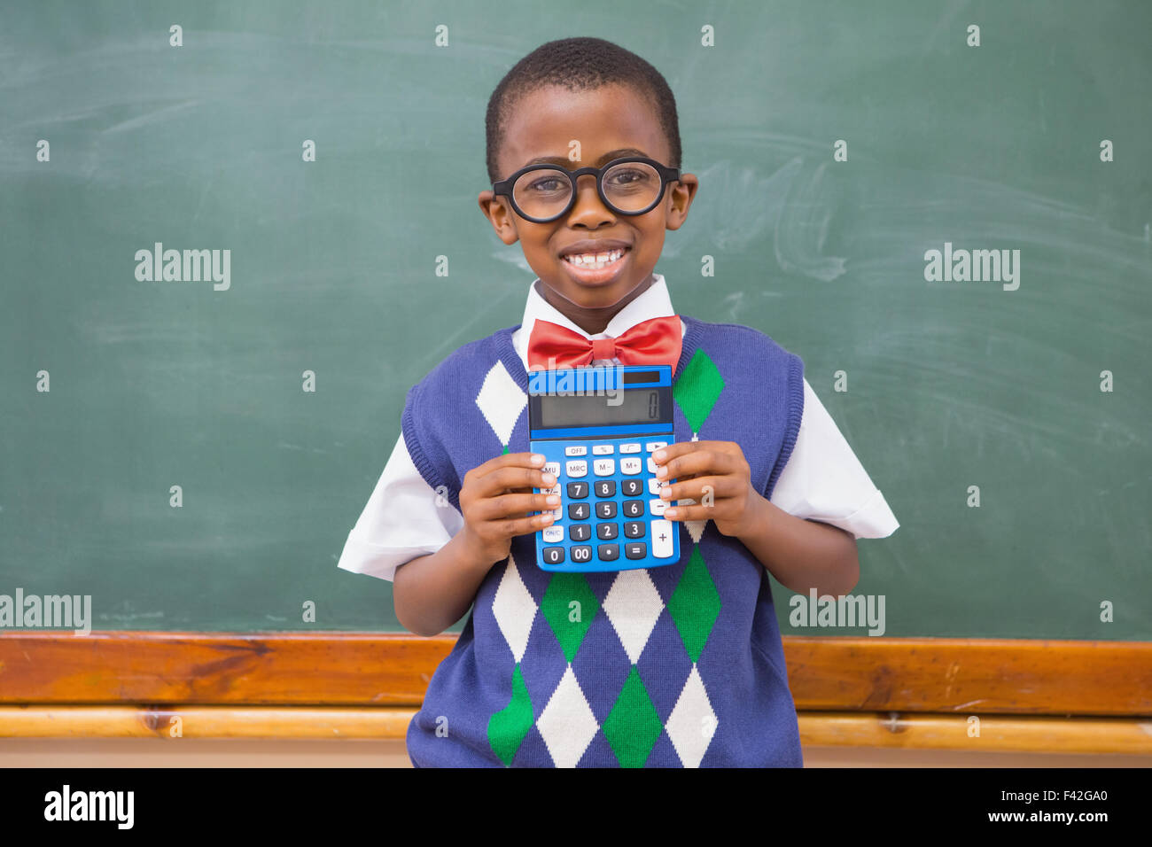 Happy pupil showing calculator Stock Photo - Alamy